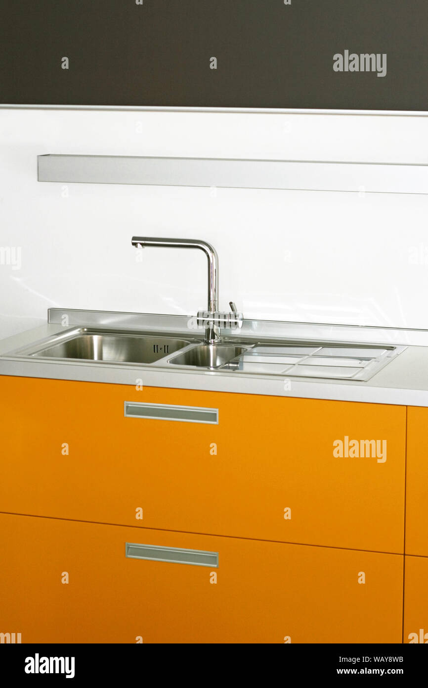 Close up shot of faucet in yellow kitchen Stock Photo - Alamy