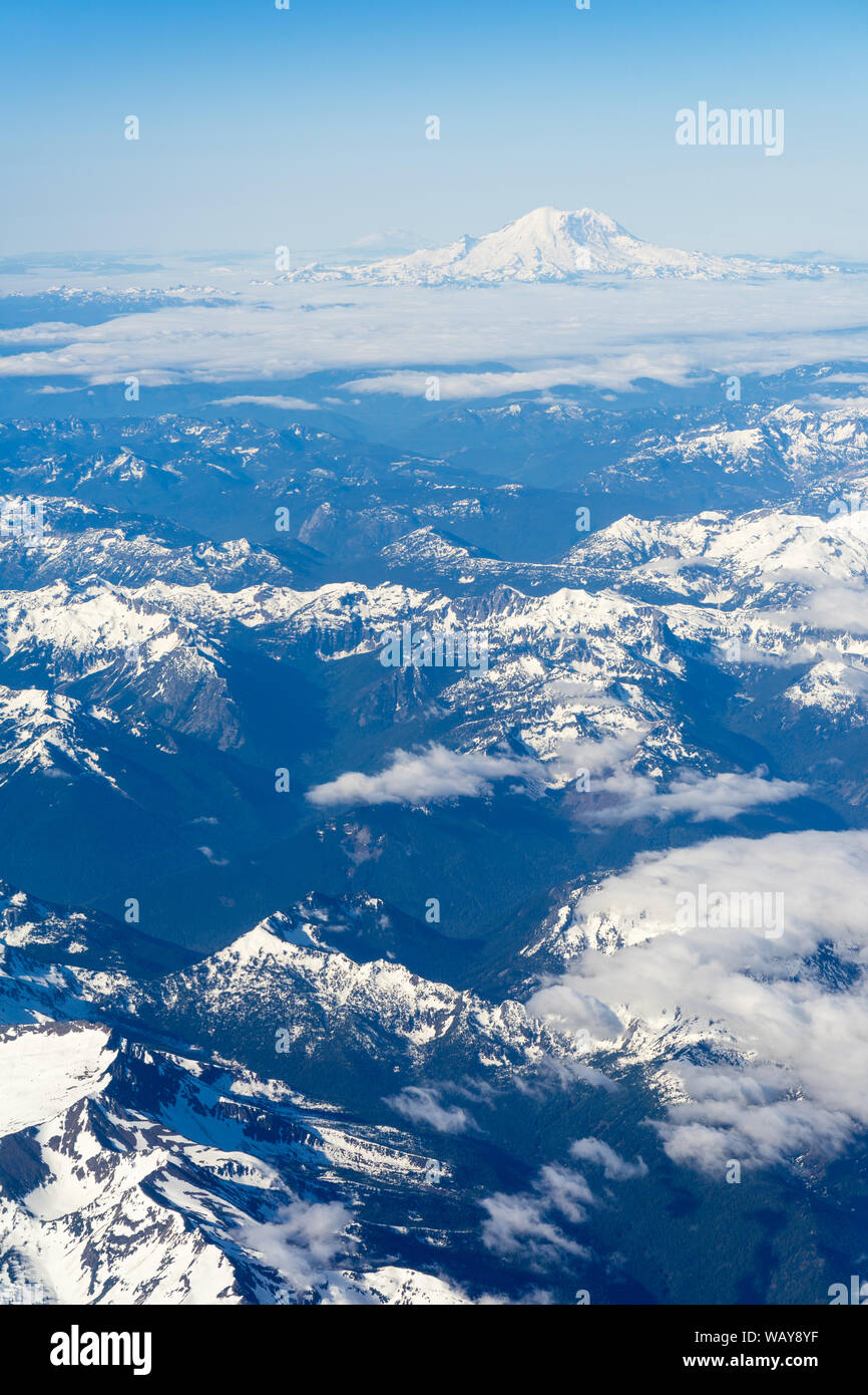 Mt Rainier with snowy peaks in the foreground from airplane Stock Photo ...