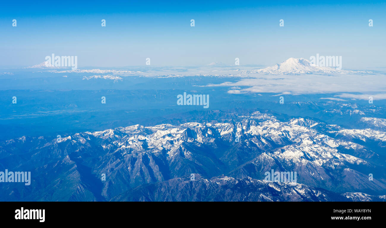 Three pacific northwest volcanoes from airplane Stock Photo - Alamy