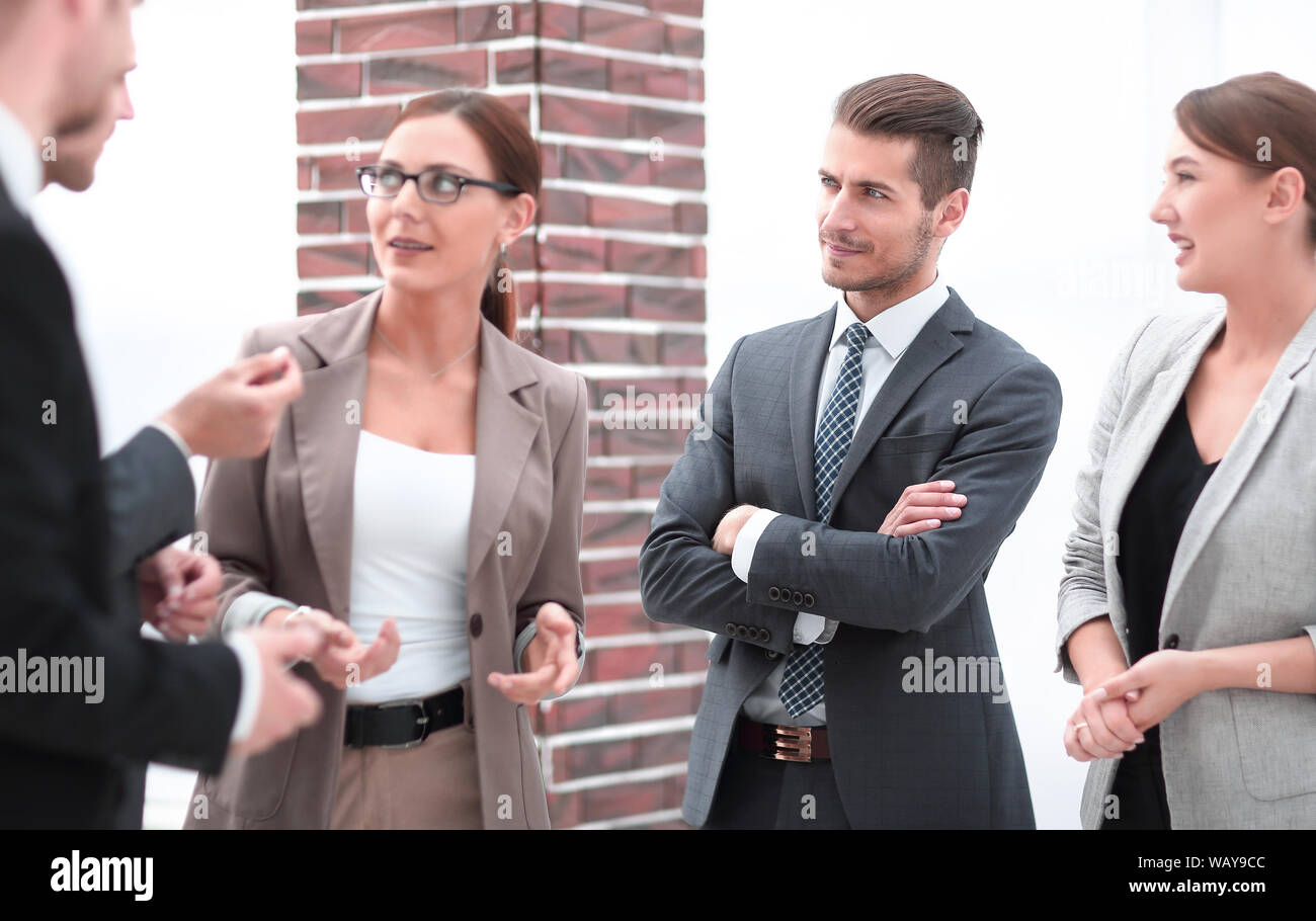 business team discusses their ideas standing in the hallway of the ...