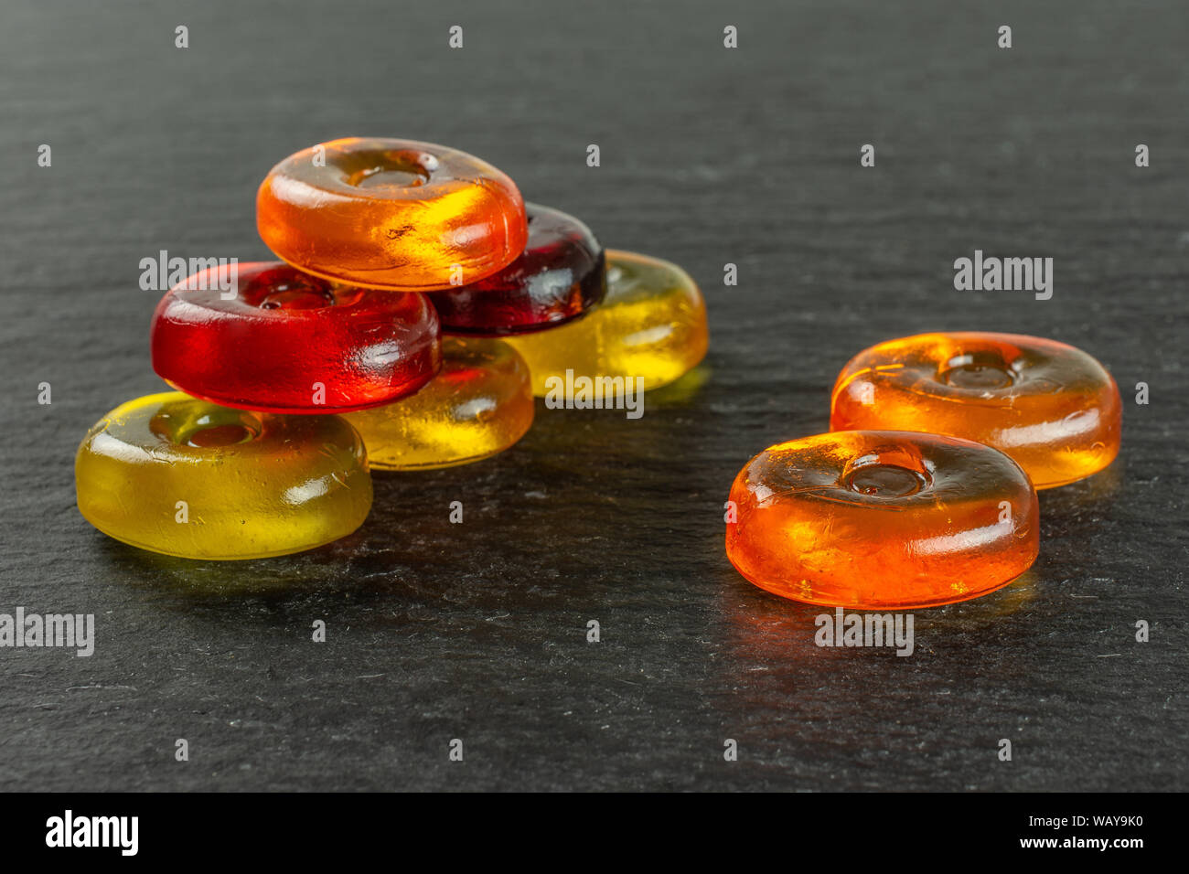 Group of eight whole colourful hard candy pyramid on grey stone Stock ...