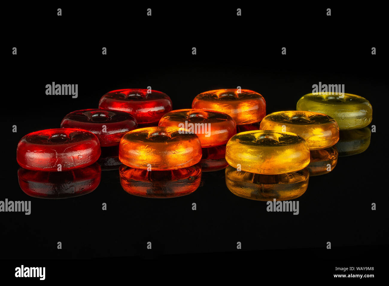 Group of nine whole colourful hard candy dark red orange yellow ...