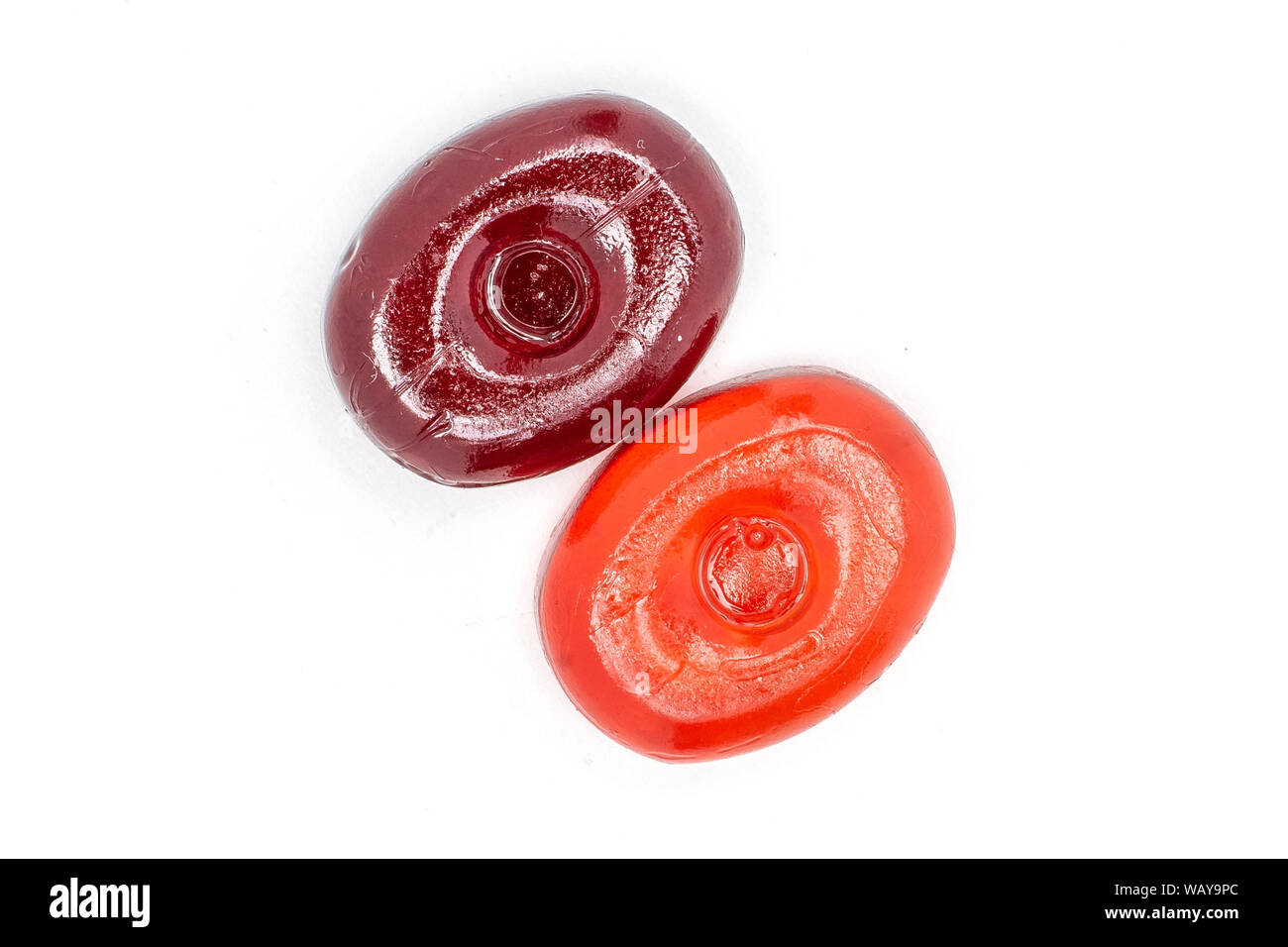 Group of two whole cherry and dark red colourful hard candy flatlay ...