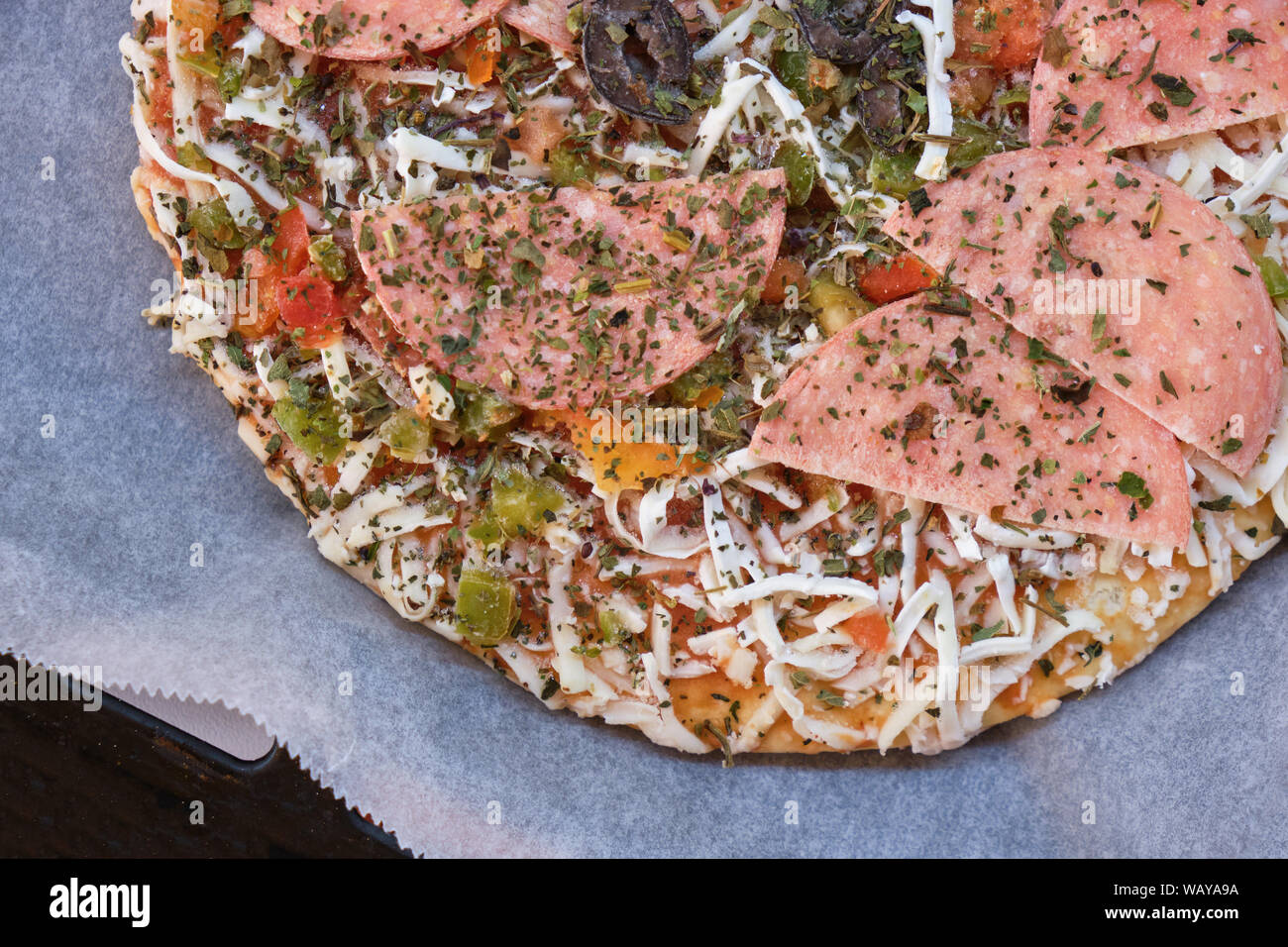 Frozen Italian pizza ready to be baked Stock Photo - Alamy