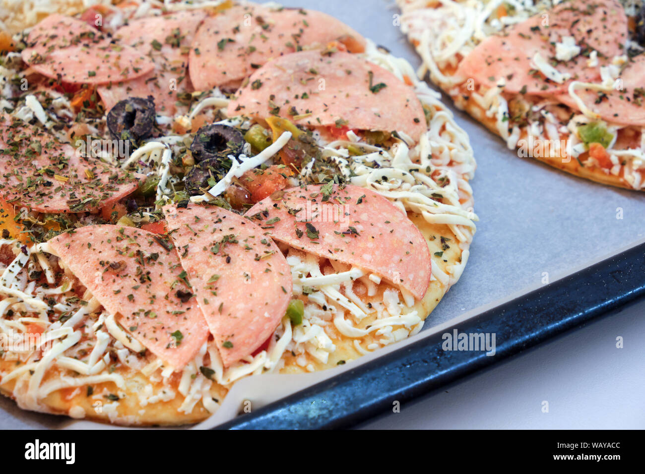 Frozen Italian pizza ready to be baked Stock Photo - Alamy