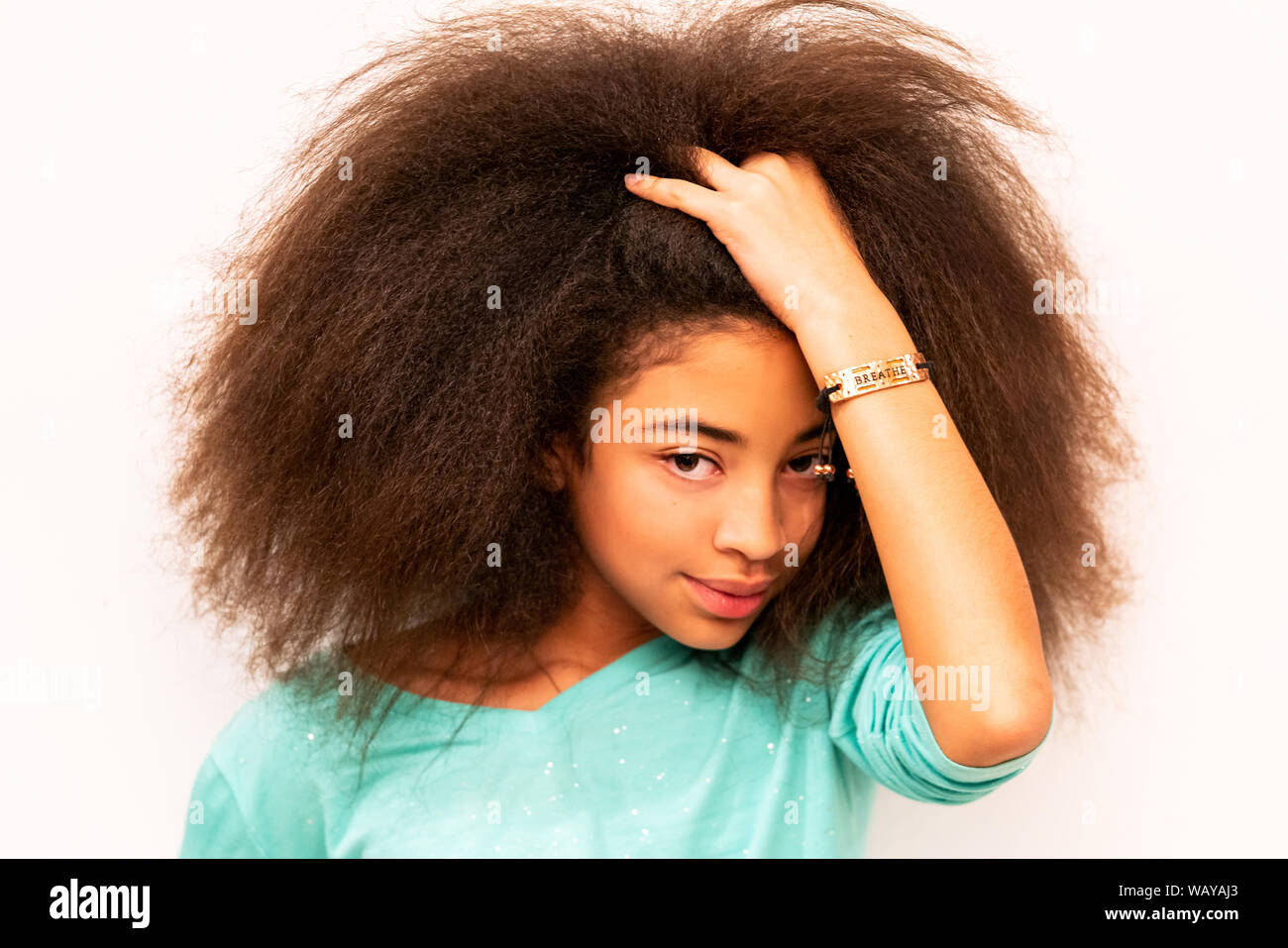 Portrait of a young mixed race girl with afro on white background Stock ...