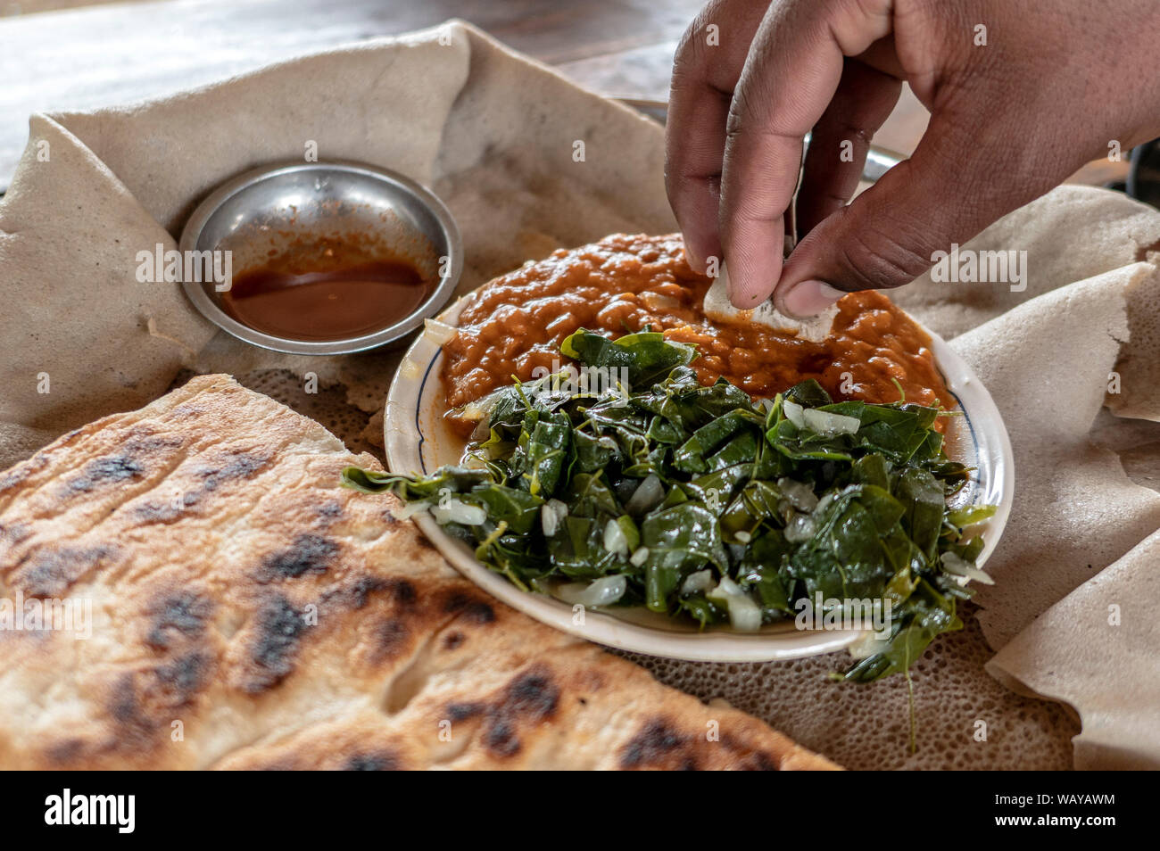 Ethiopian man eating injera hi-res stock photography and images - Alamy