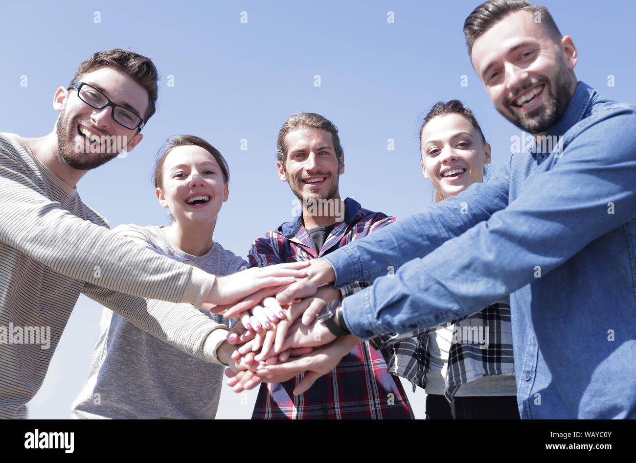 Standing friends joined hands hi-res stock photography and images - Alamy