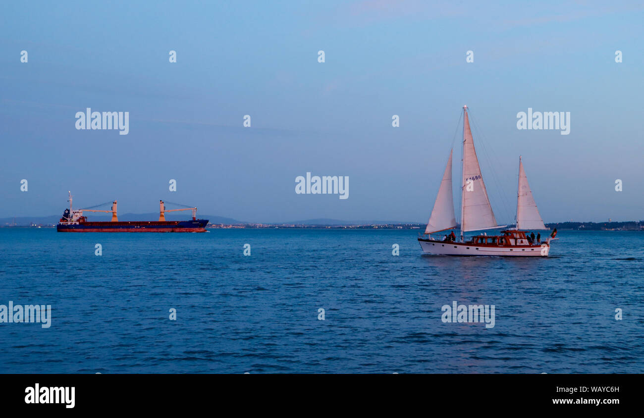 Boat and ship crossing in Tejo River Stock Photo - Alamy
