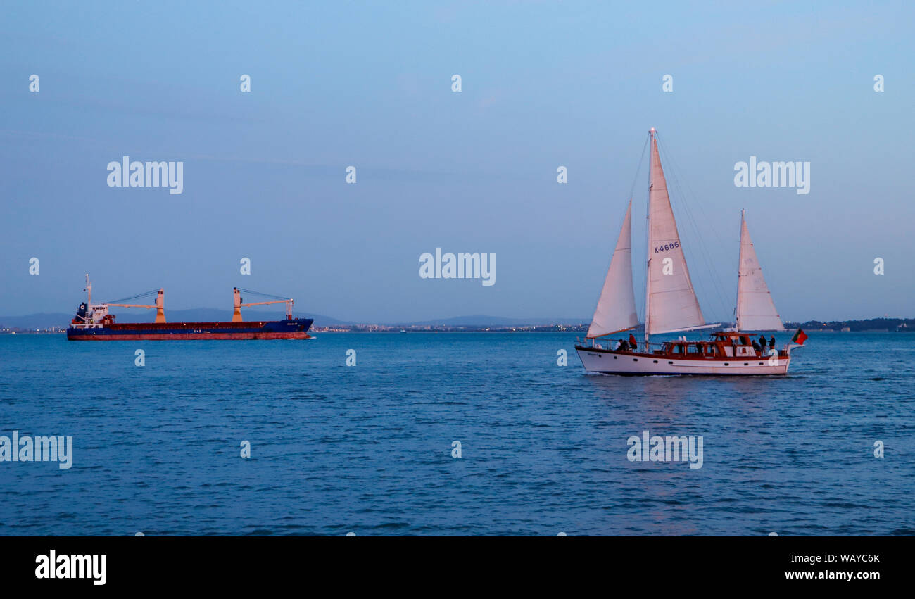 Boat and ship crossing in Tejo River Stock Photo - Alamy