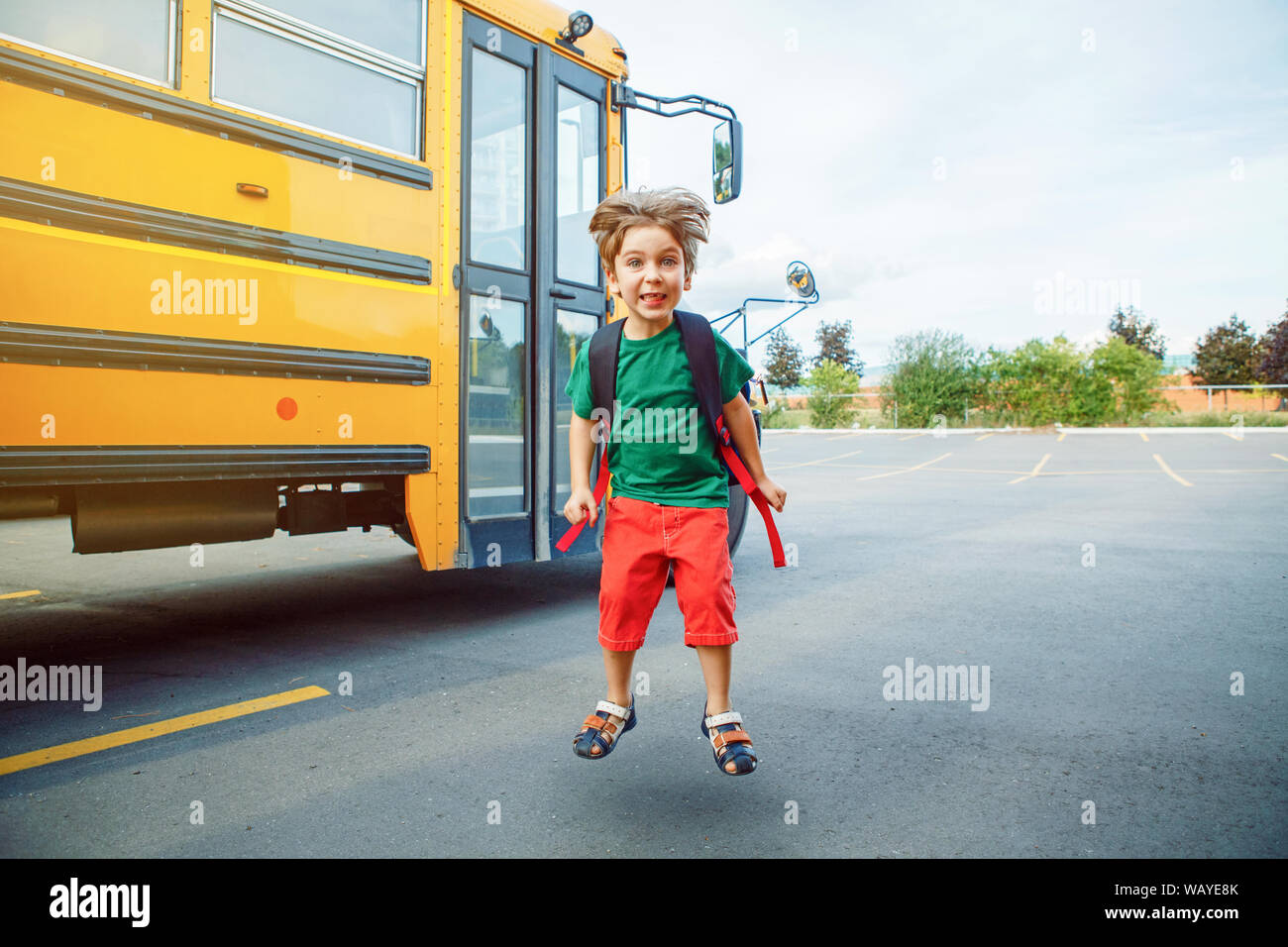 Emotional Caucasian boy student kid with funny face expression jumping ...