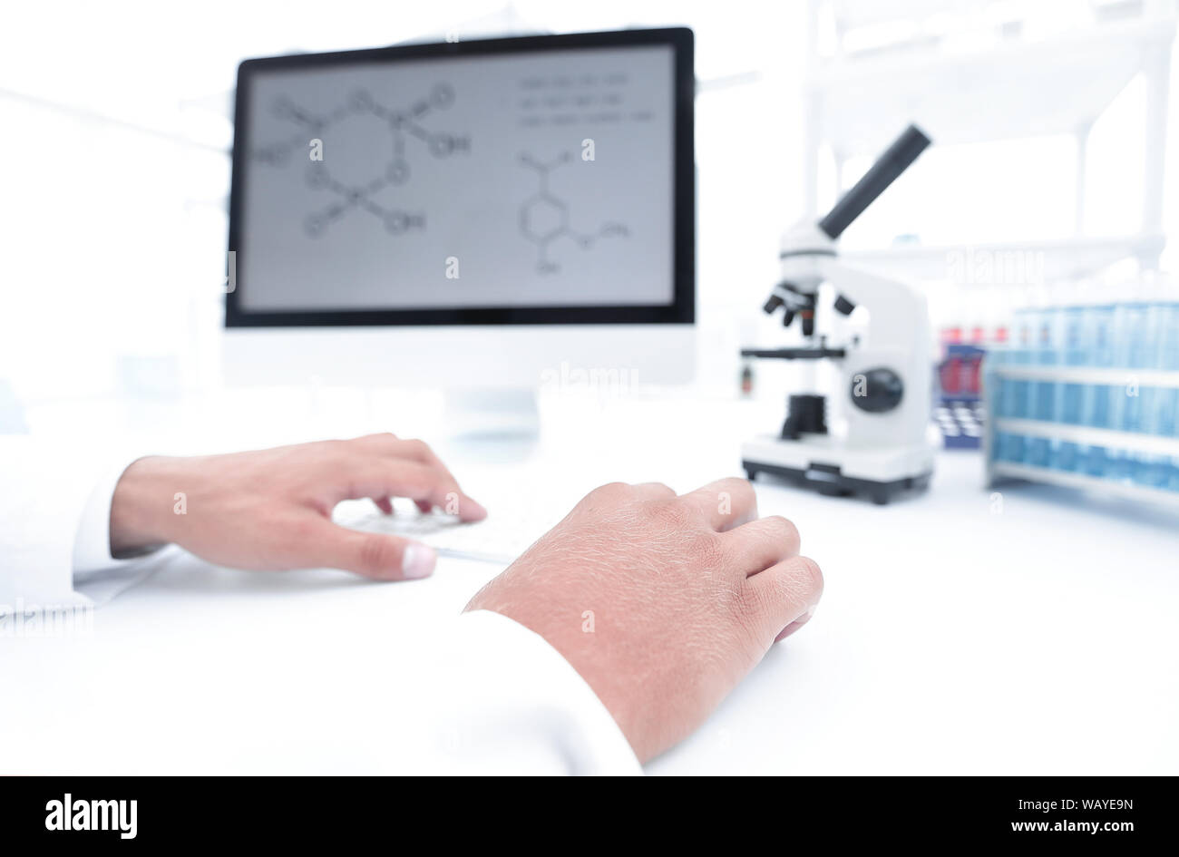 A scientist uses a computer and a microscope Stock Photo - Alamy