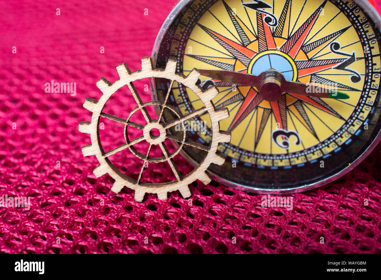 Gear wheel and a compass as The concept of mechanism Stock Photo - Alamy