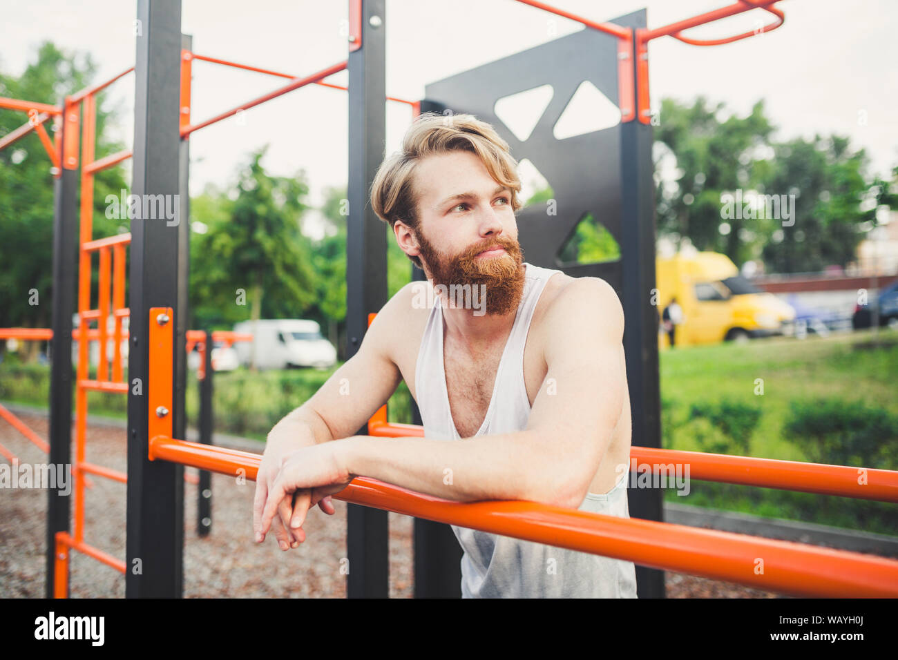 Portrait of Tired Athlete at Gym. Tired man hanging from the bar ...