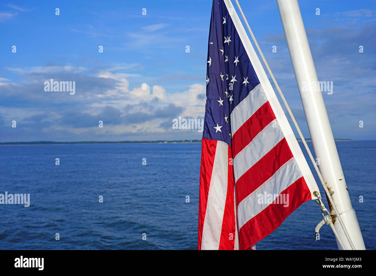 American flag of the United States of America floating off a ferry on ...