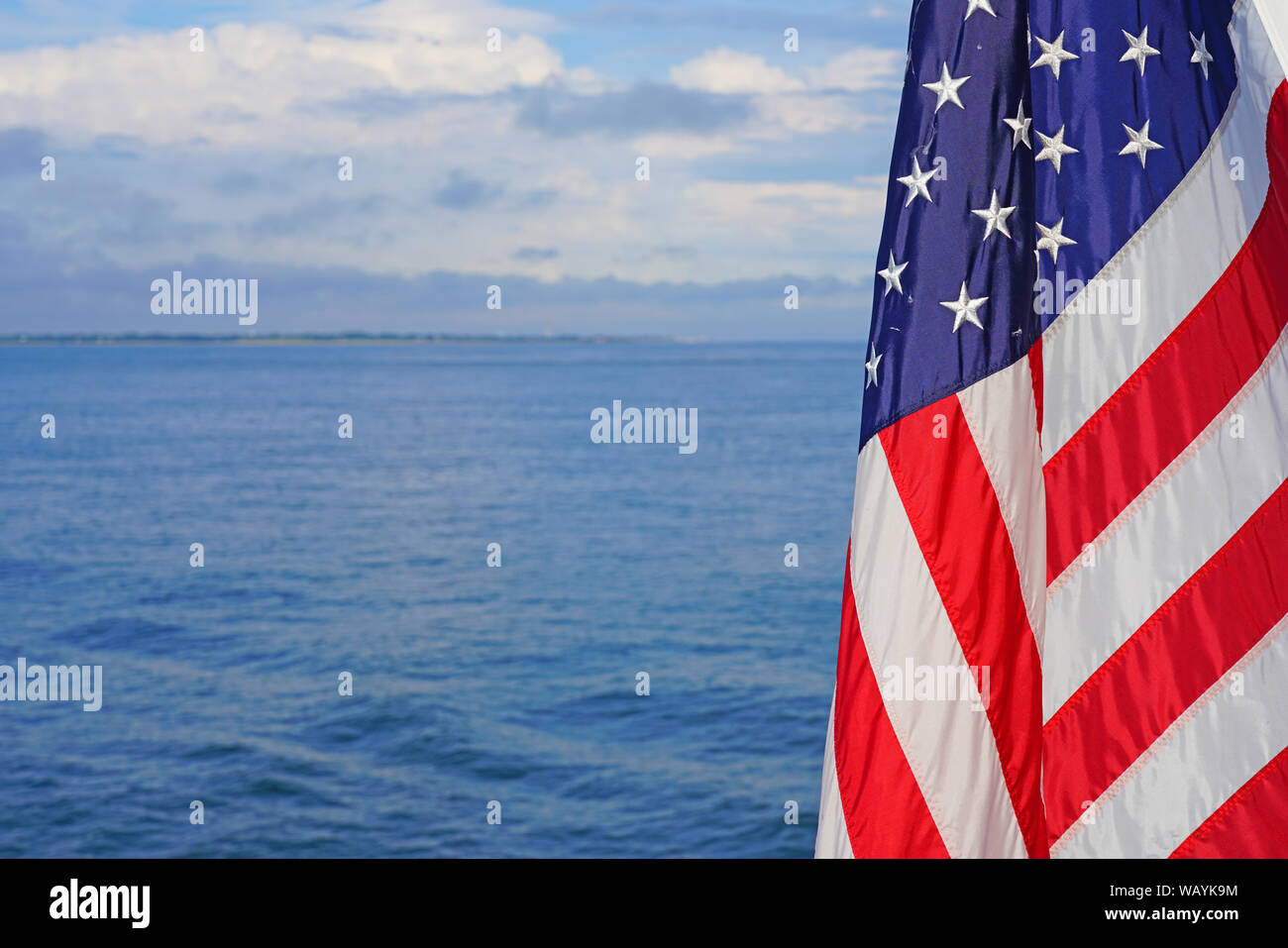 American flag of the United States of America floating off a ferry on ...
