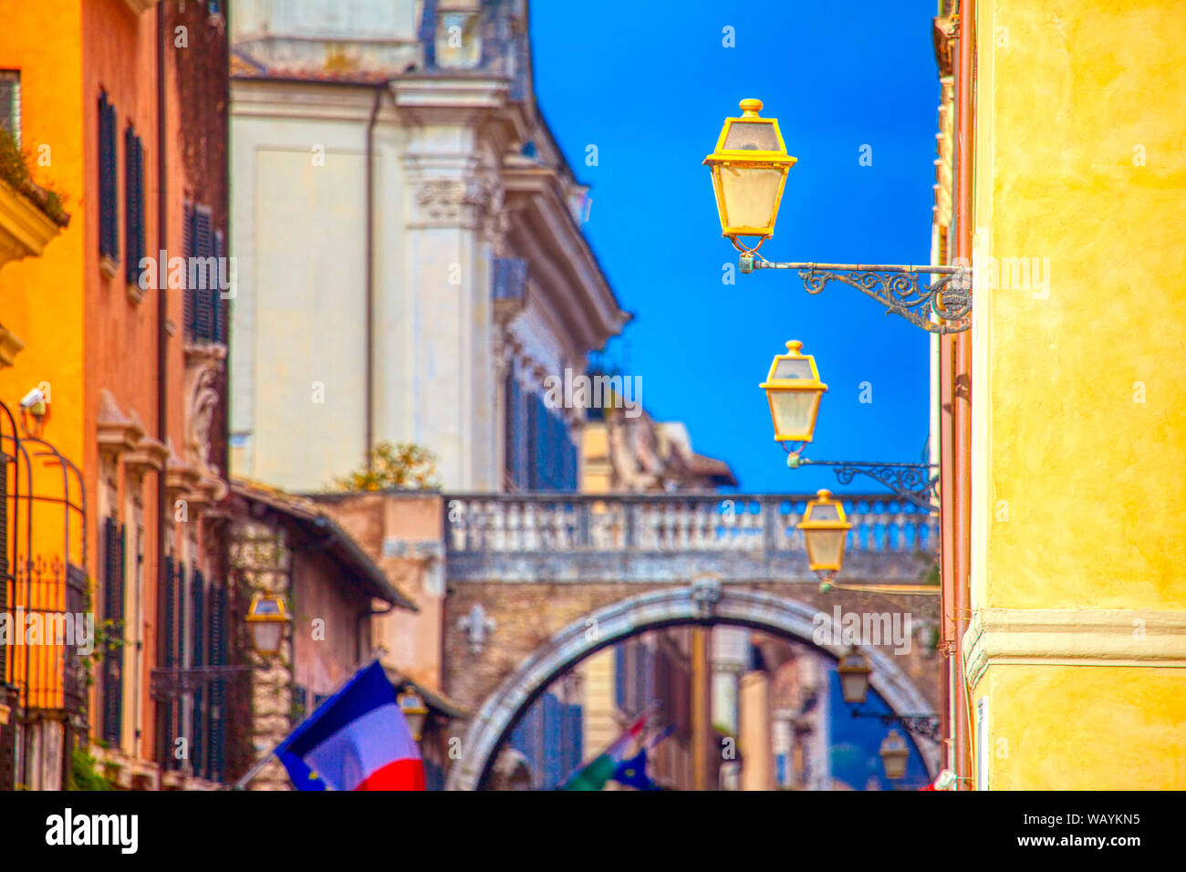 European alley with flags and street lamps Stock Photo - Alamy