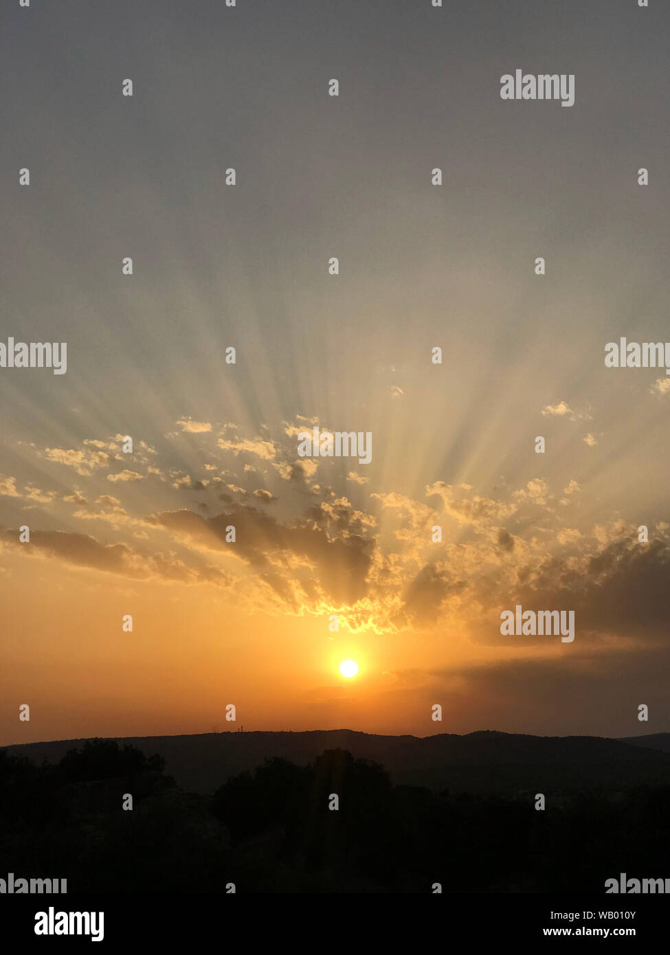 Sunset with clouds and rays Stock Photo - Alamy