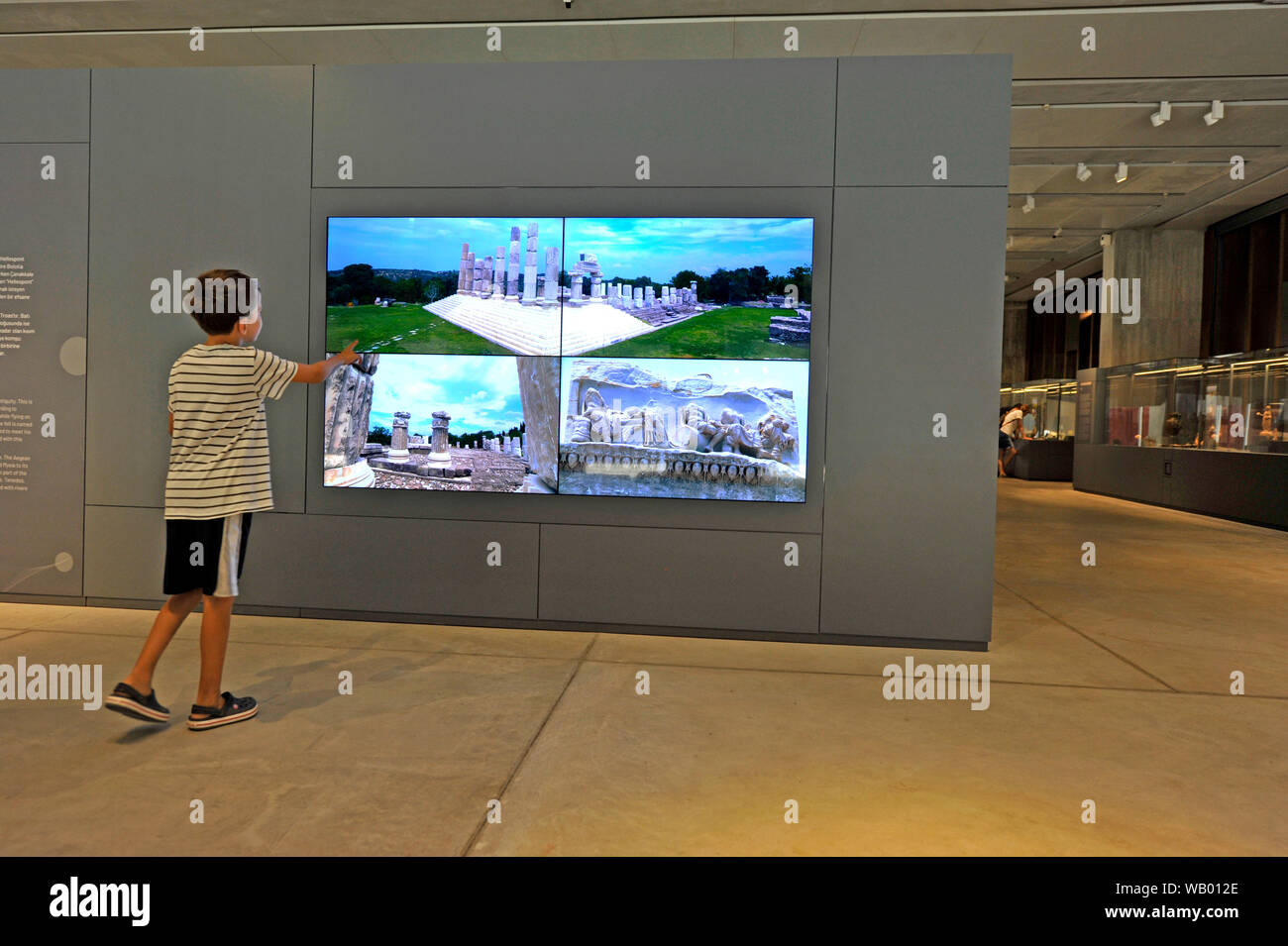 A young boy looks at a back lit display at the Troy Museum in Turkey ...