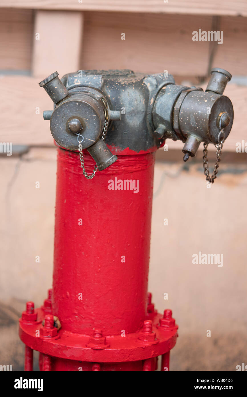 Red fire hydrant water pipe with a chain on the street Stock Photo - Alamy