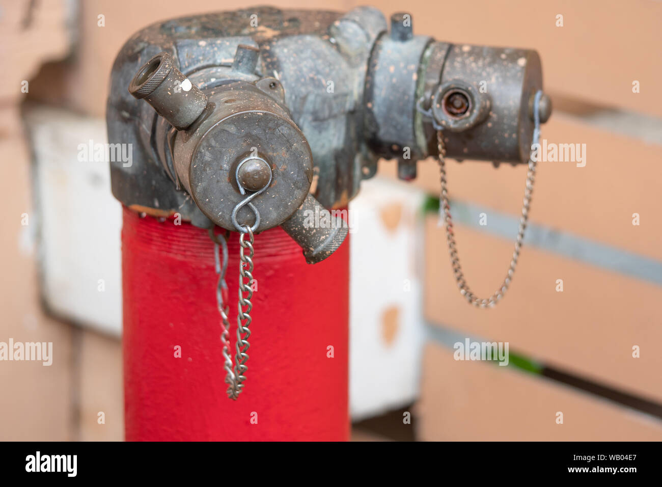 Red fire hydrant water pipe with a chain on the street Stock Photo - Alamy