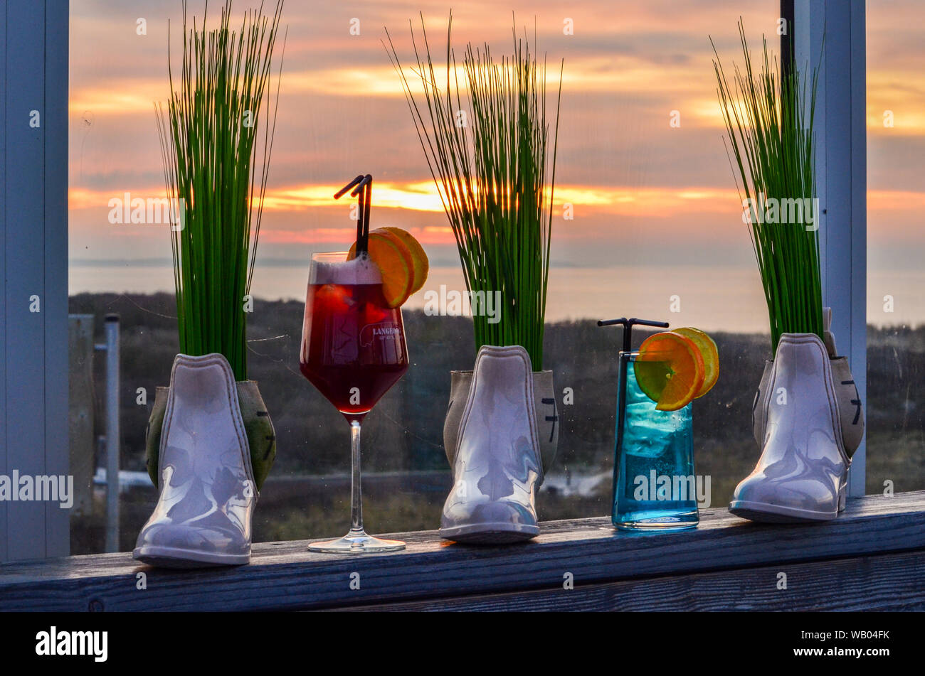 Cocktail glasses with the Sunset in the background Stock Photo - Alamy