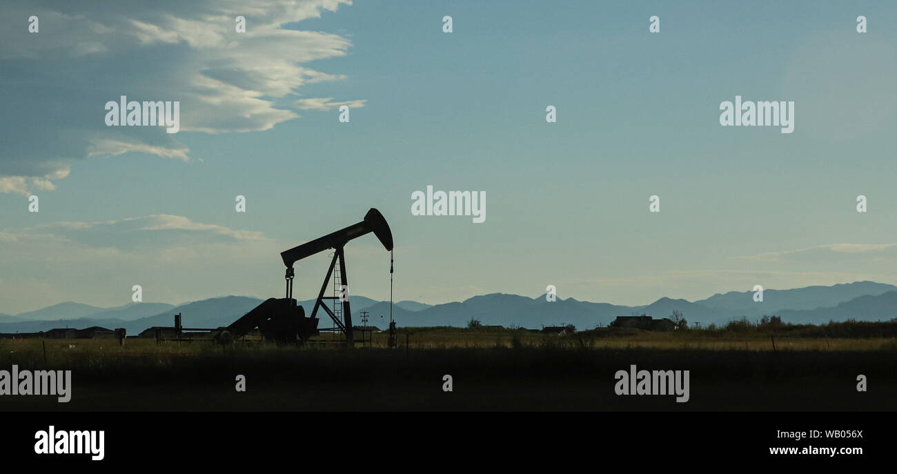 Oil Derrick, pumping and drilling well in field Stock Photo - Alamy