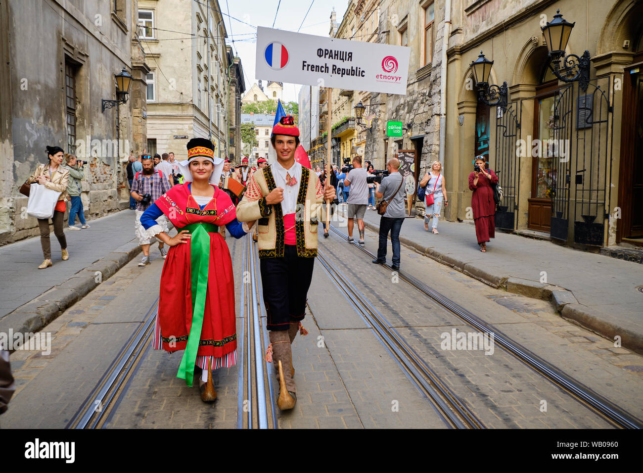 French Pyrenees Folklore group in local costume banner bearer walking ...
