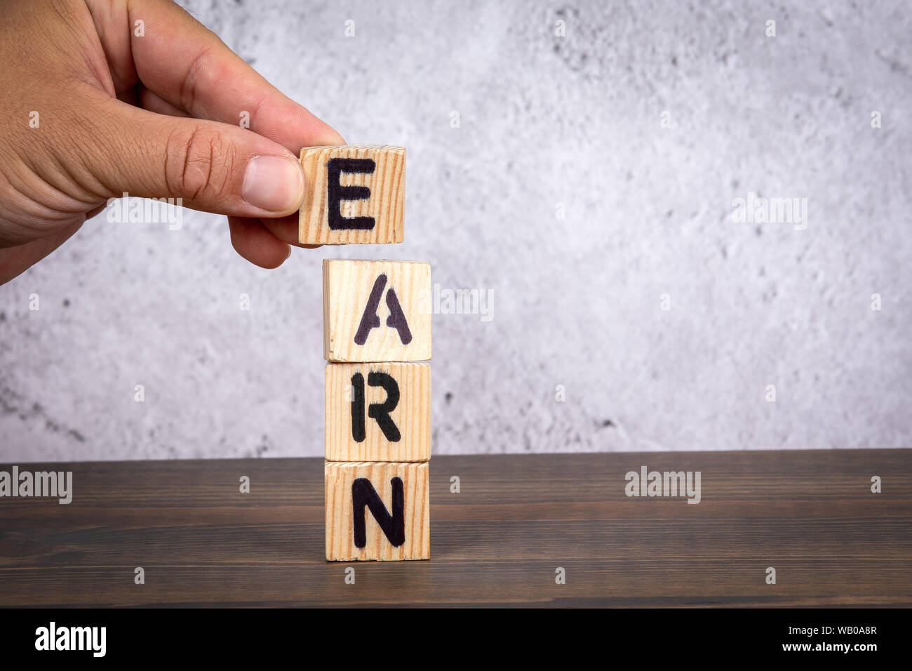 Earn. Business, investment and insurance concept. Wooden letters on the ...