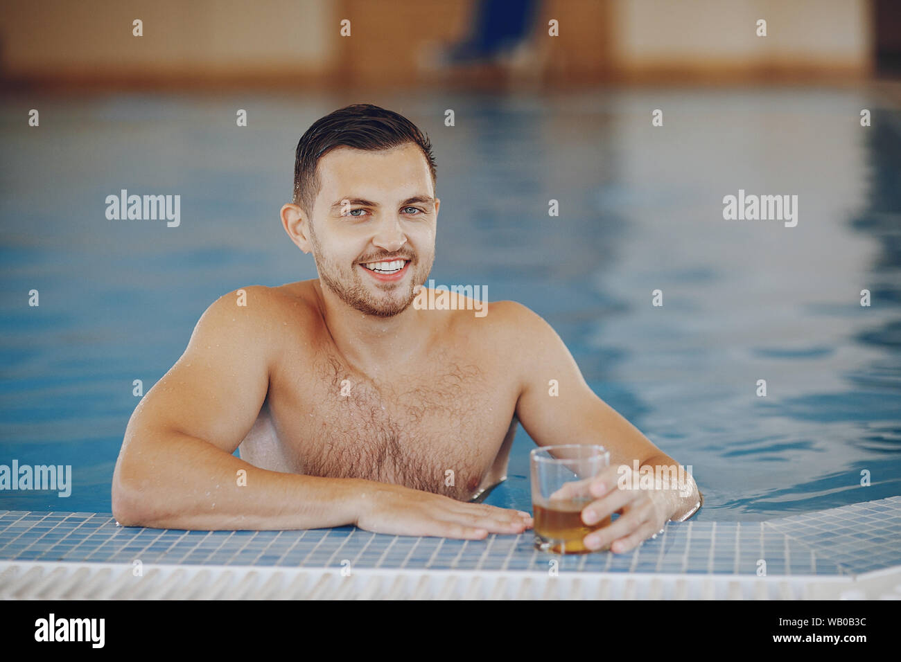Handsome man floating in pool hi-res stock photography and images - Alamy