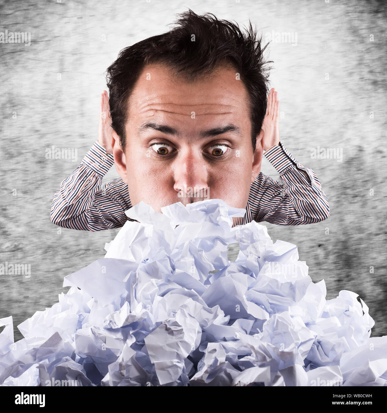 Business man with a great heap of crumpled papers. Swimming in paper ...