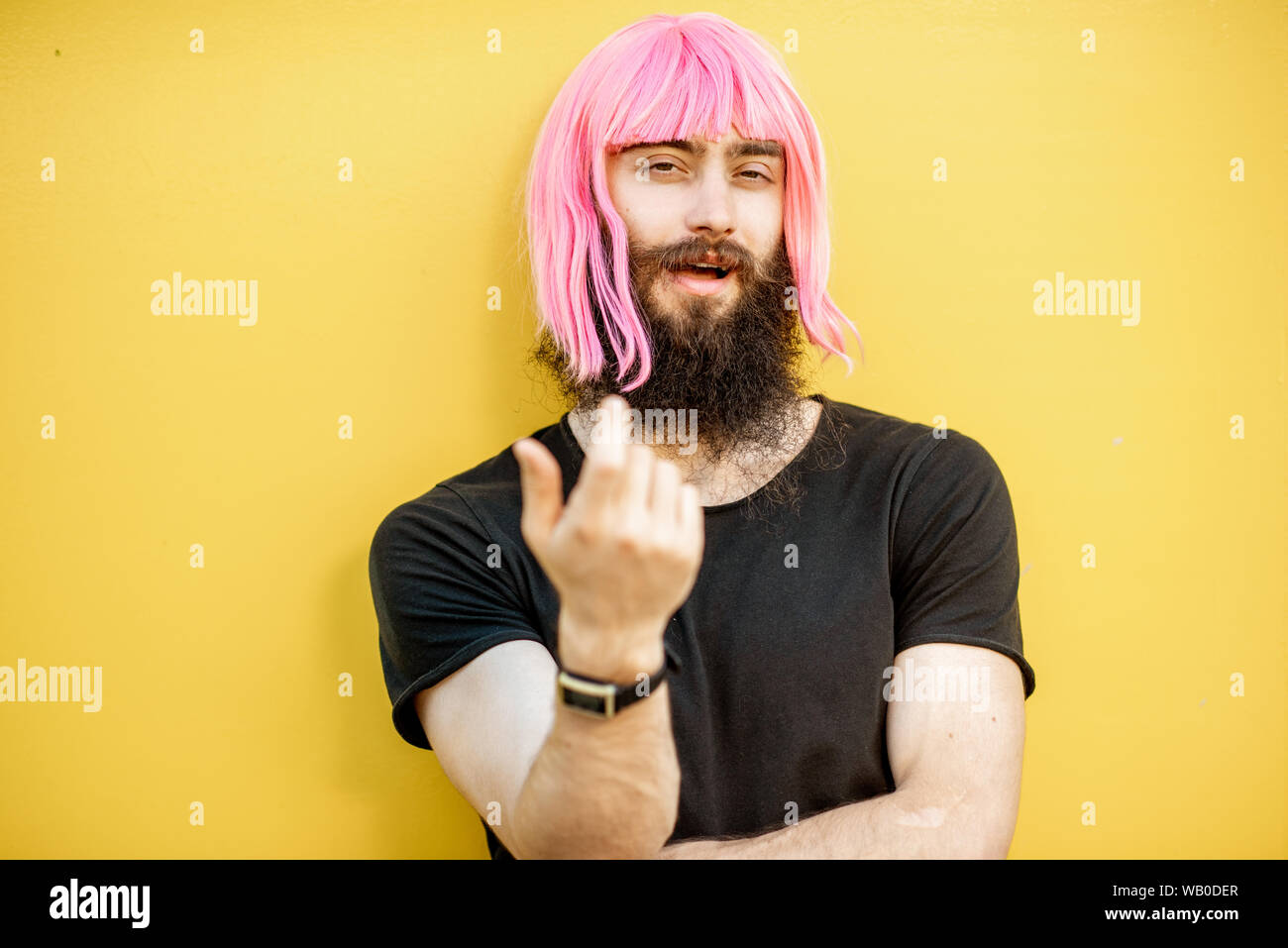 Funny portrait of a stylish playful man with beard and long color hair ...