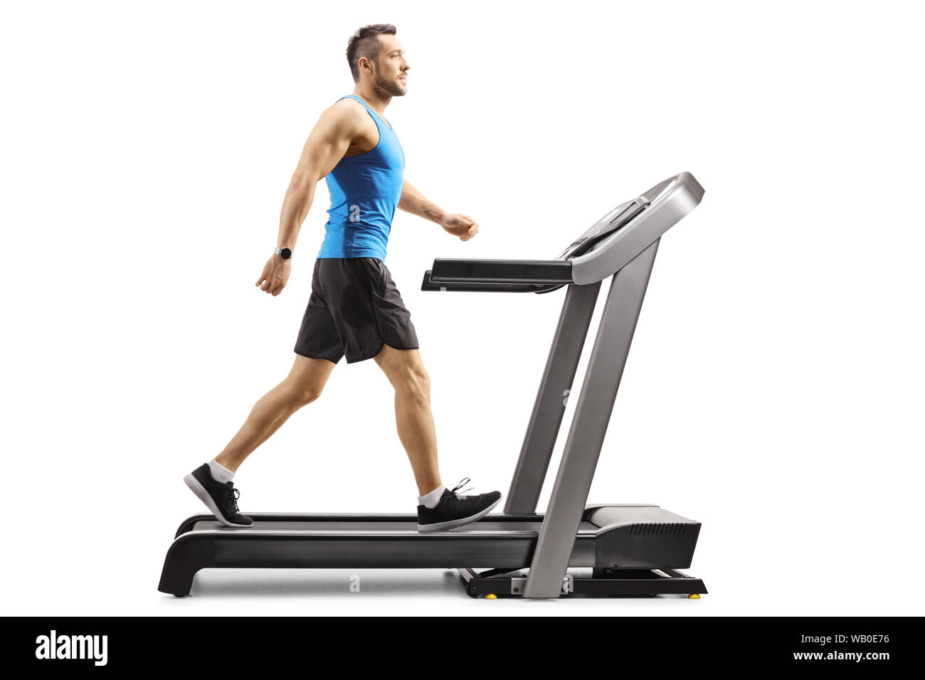 Full length profile shot of a young man walking on a professional ...