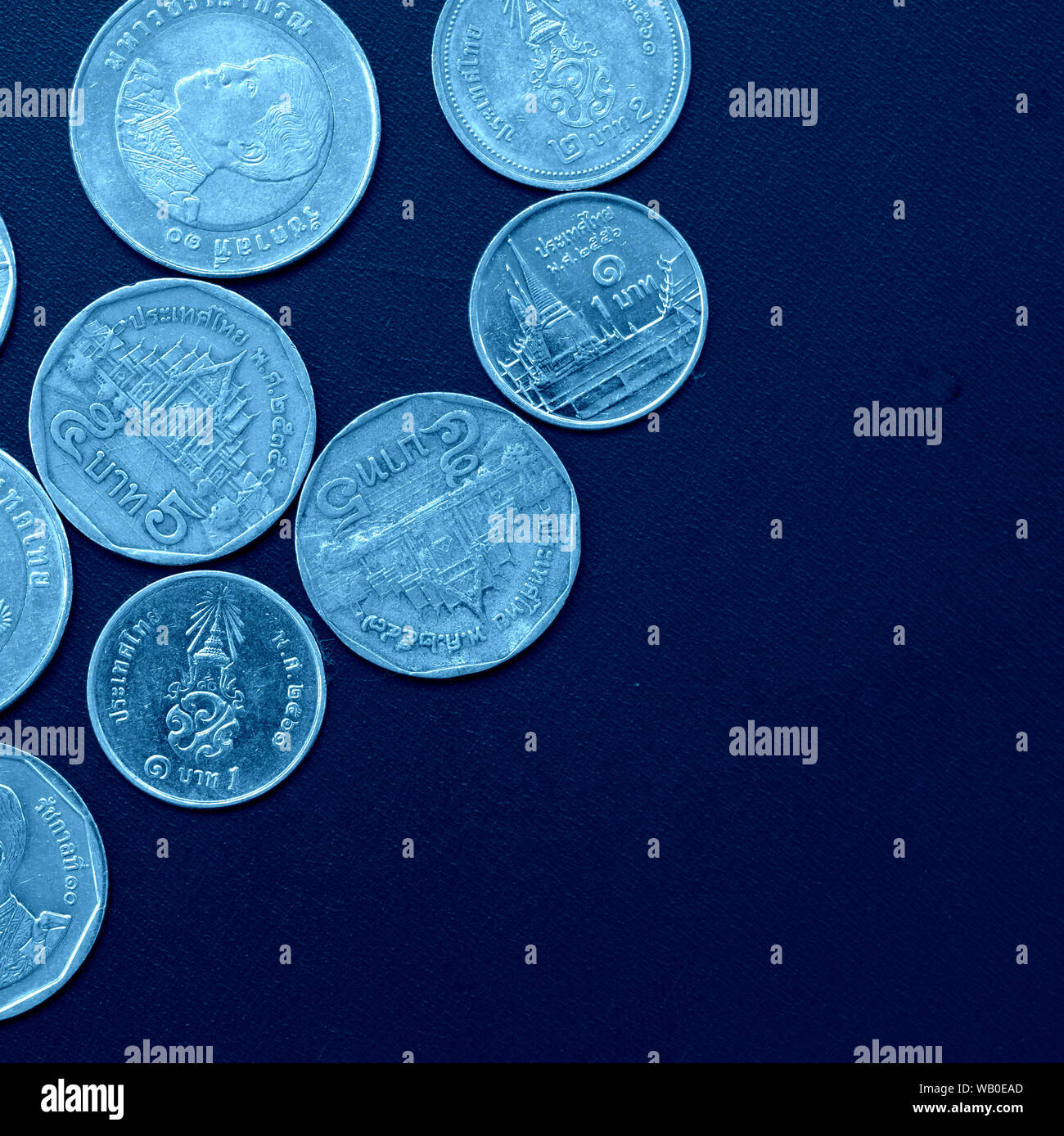 Thai Baht coins blue color toned close up, top view, square crop Stock ...