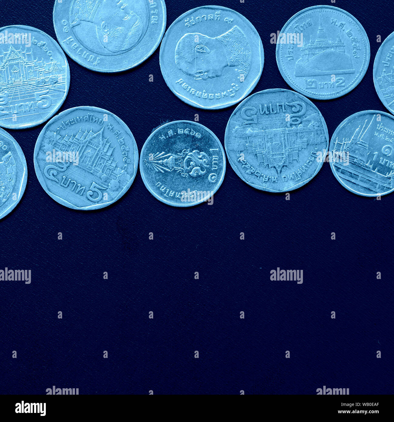 Thai Baht coins blue color toned close up, top view, square crop Stock ...