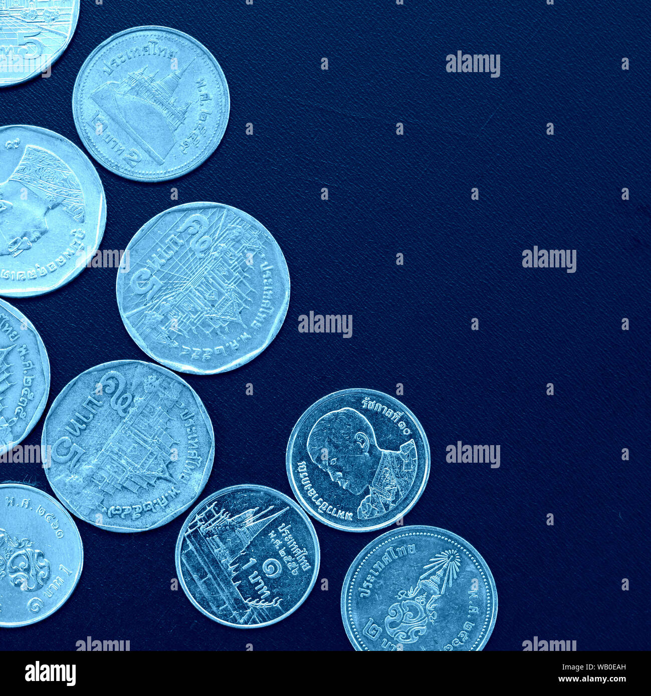 Thai Baht coins blue color toned close up, top view, square crop Stock ...
