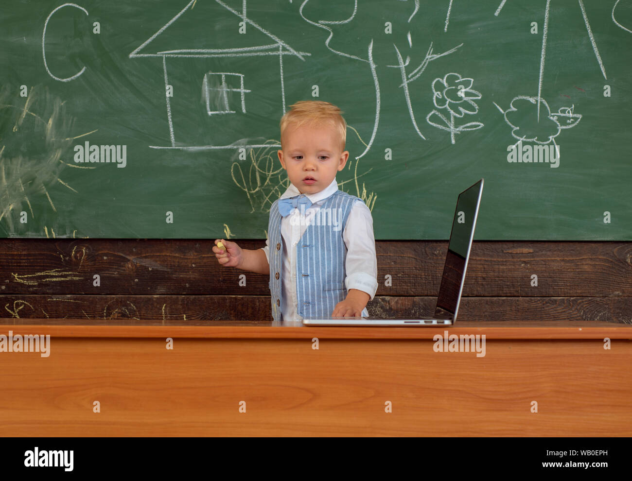 Computing technology for school education. Little child use laptop ...