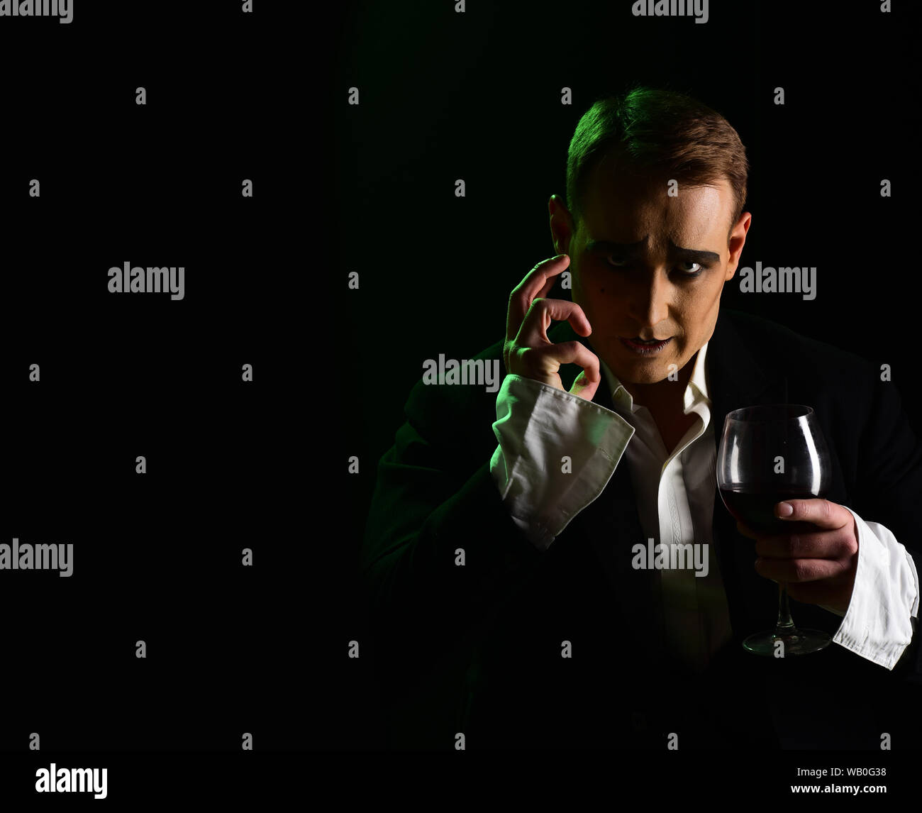 Improvising. Comedian man with mime makeup hold wine glass. Drama ...