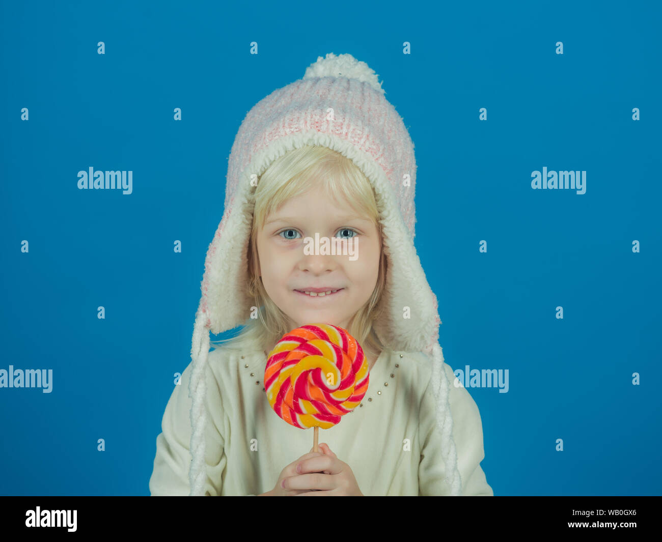 A sweet tooth. Little girl hold lollipop on stick. Little child with ...