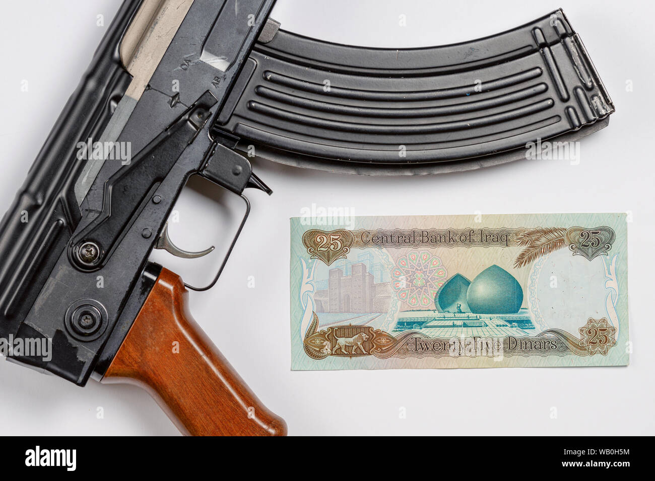 old Iraqi money depicting Saddam Hussein along with the Soviet AK 47 ...
