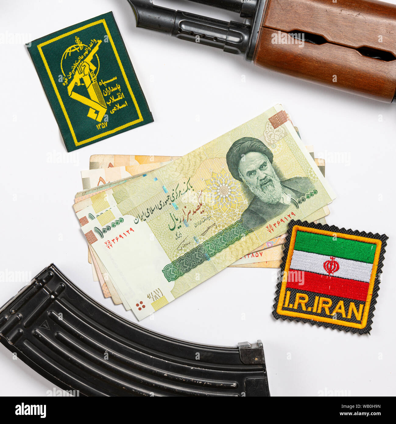 Soviet automaton AK 47 against the backdrop of Iranian money depicting ...