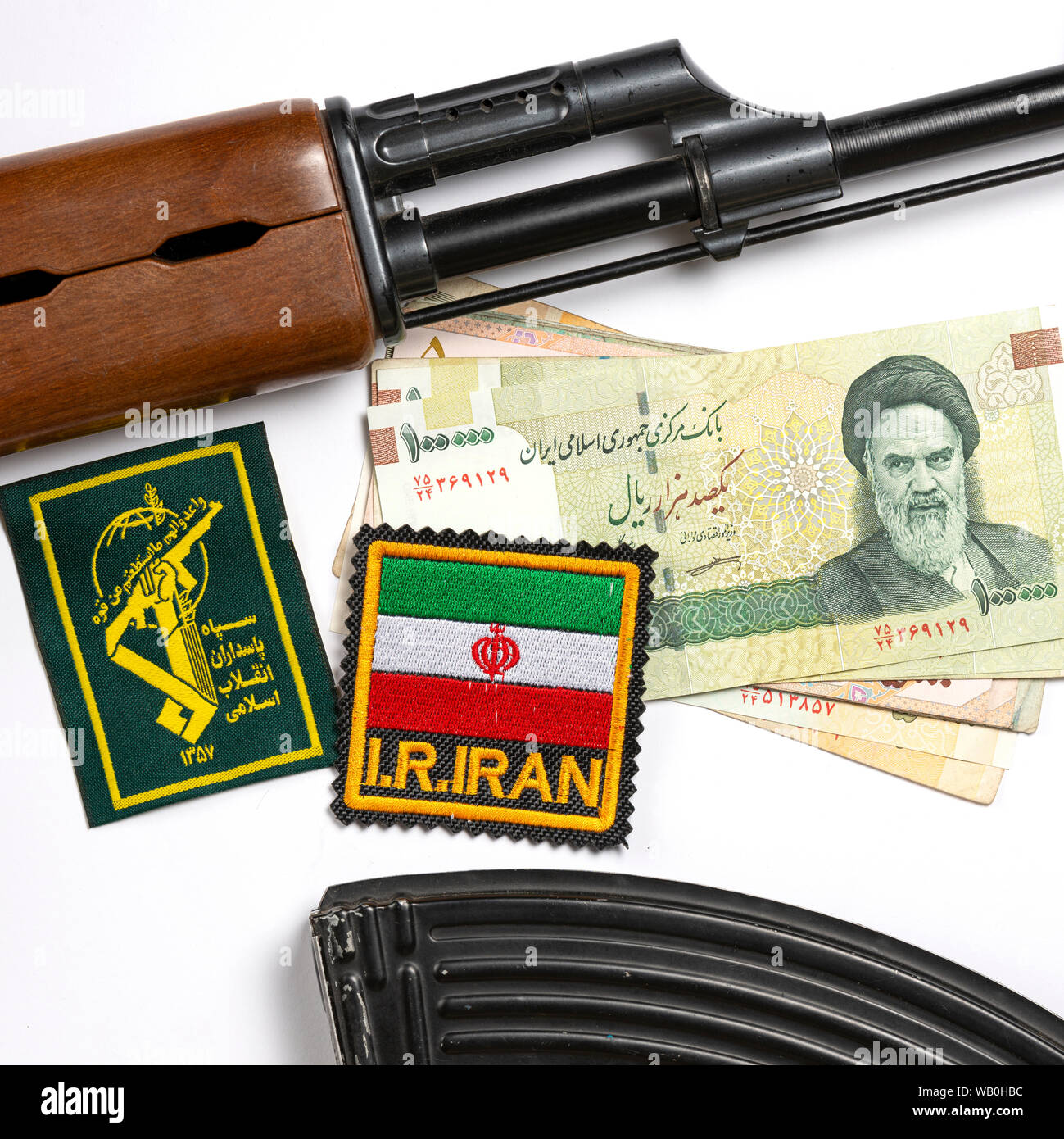 Soviet automaton AK 47 against the backdrop of Iranian money depicting ...