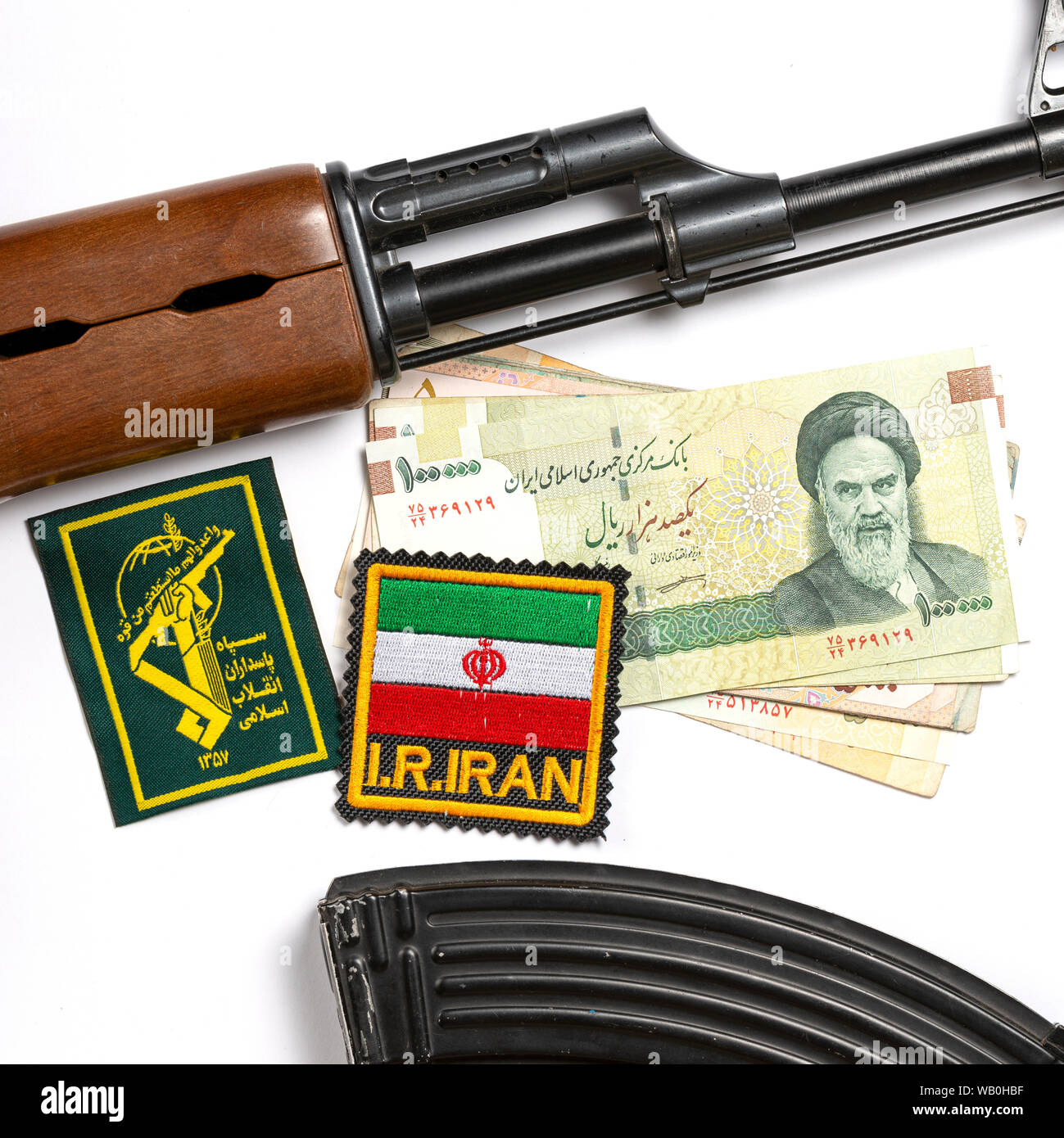 Soviet automaton AK 47 against the backdrop of Iranian money depicting ...