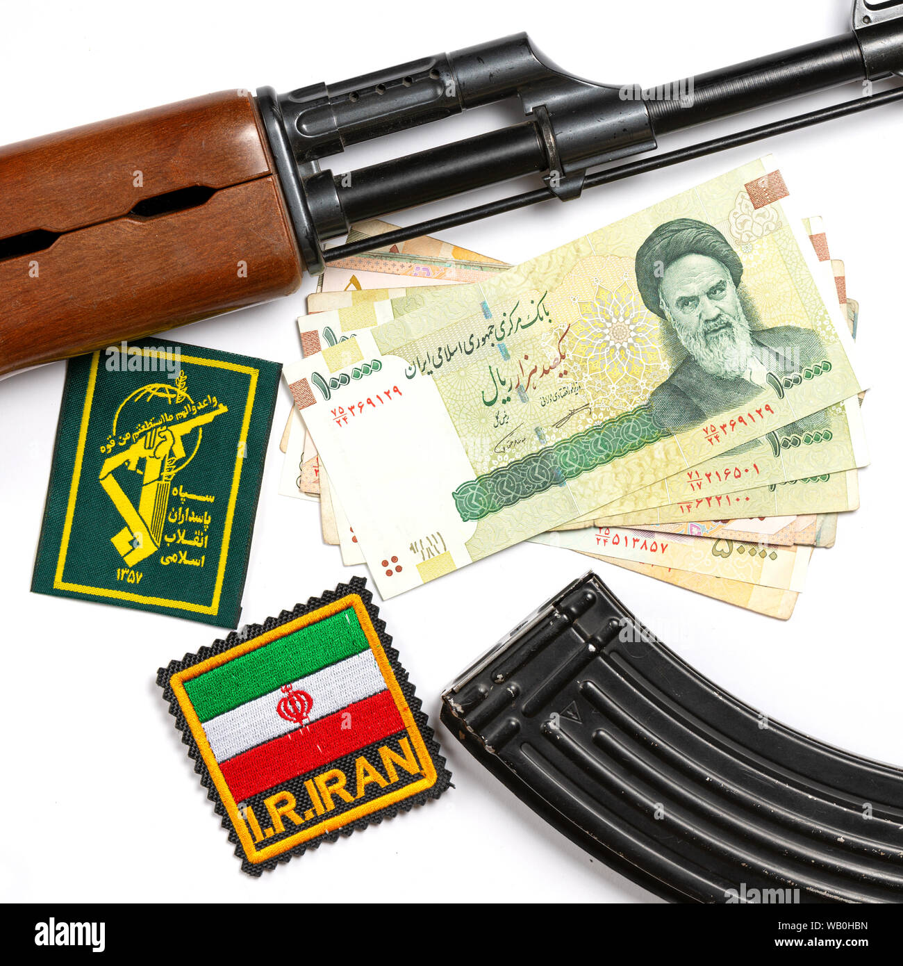 Soviet automaton AK 47 against the backdrop of Iranian money depicting ...