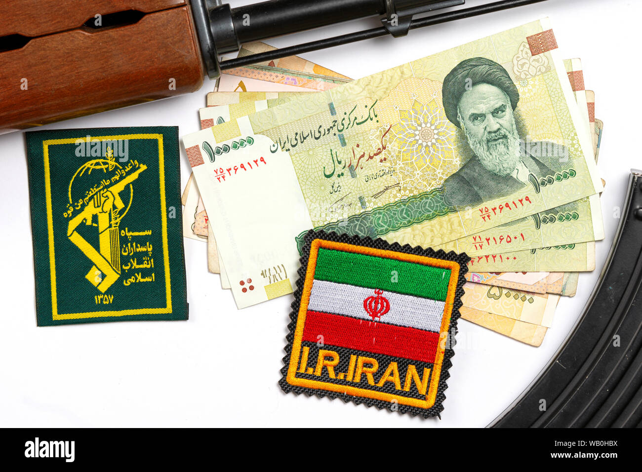 Soviet automaton AK 47 against the backdrop of Iranian money depicting ...
