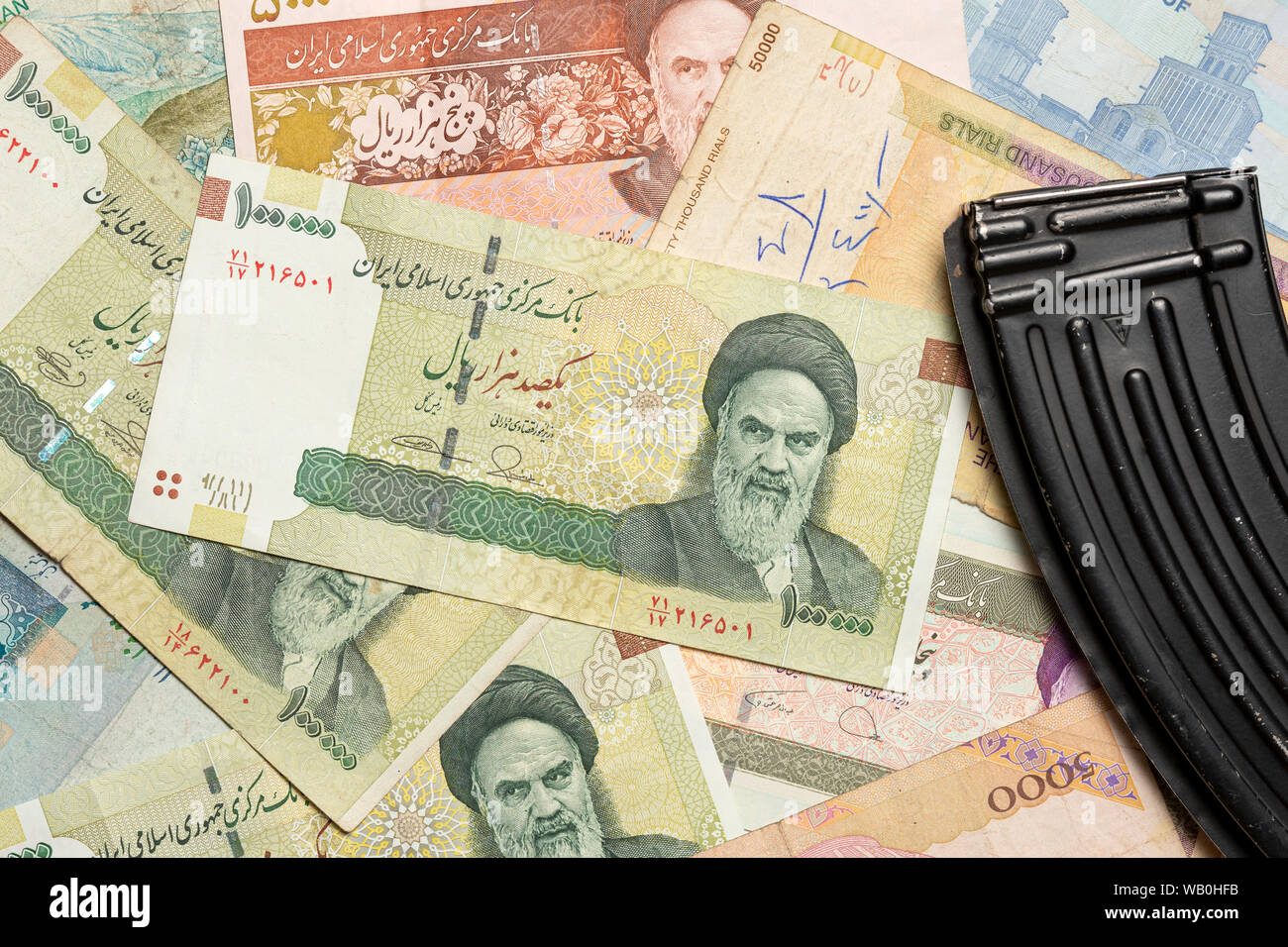 Soviet automaton AK 47 against the backdrop of Iranian money depicting ...