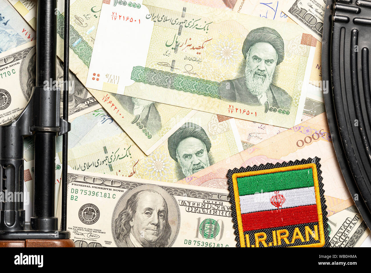 Soviet automaton AK 47 against the backdrop of Iranian money depicting ...