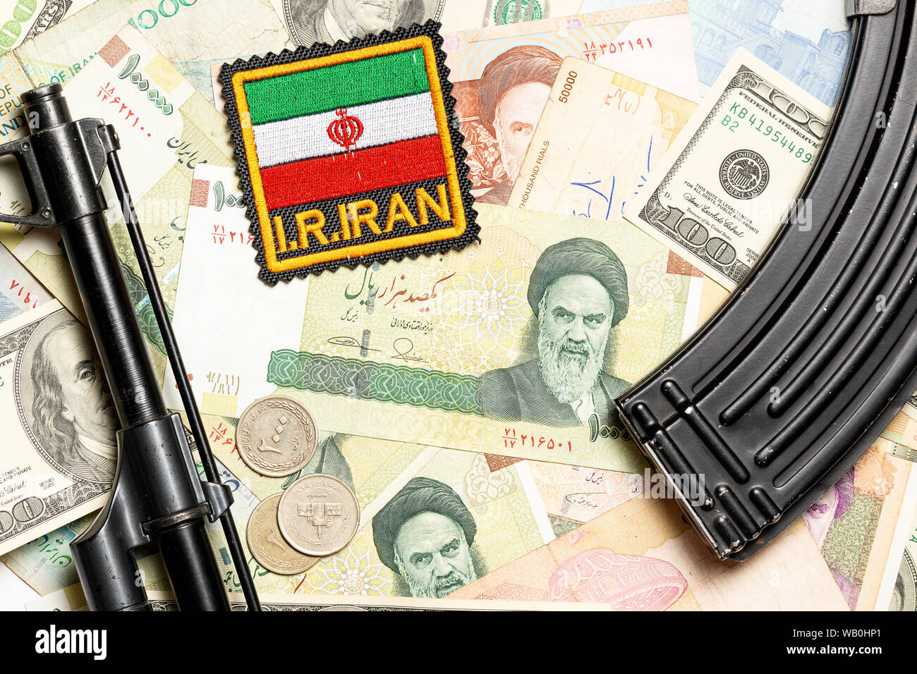 Soviet automaton AK 47 against the backdrop of Iranian money depicting ...