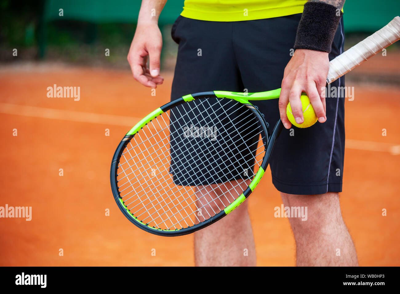 Close up male tennis player holding racket and ball Stock Photo - Alamy
