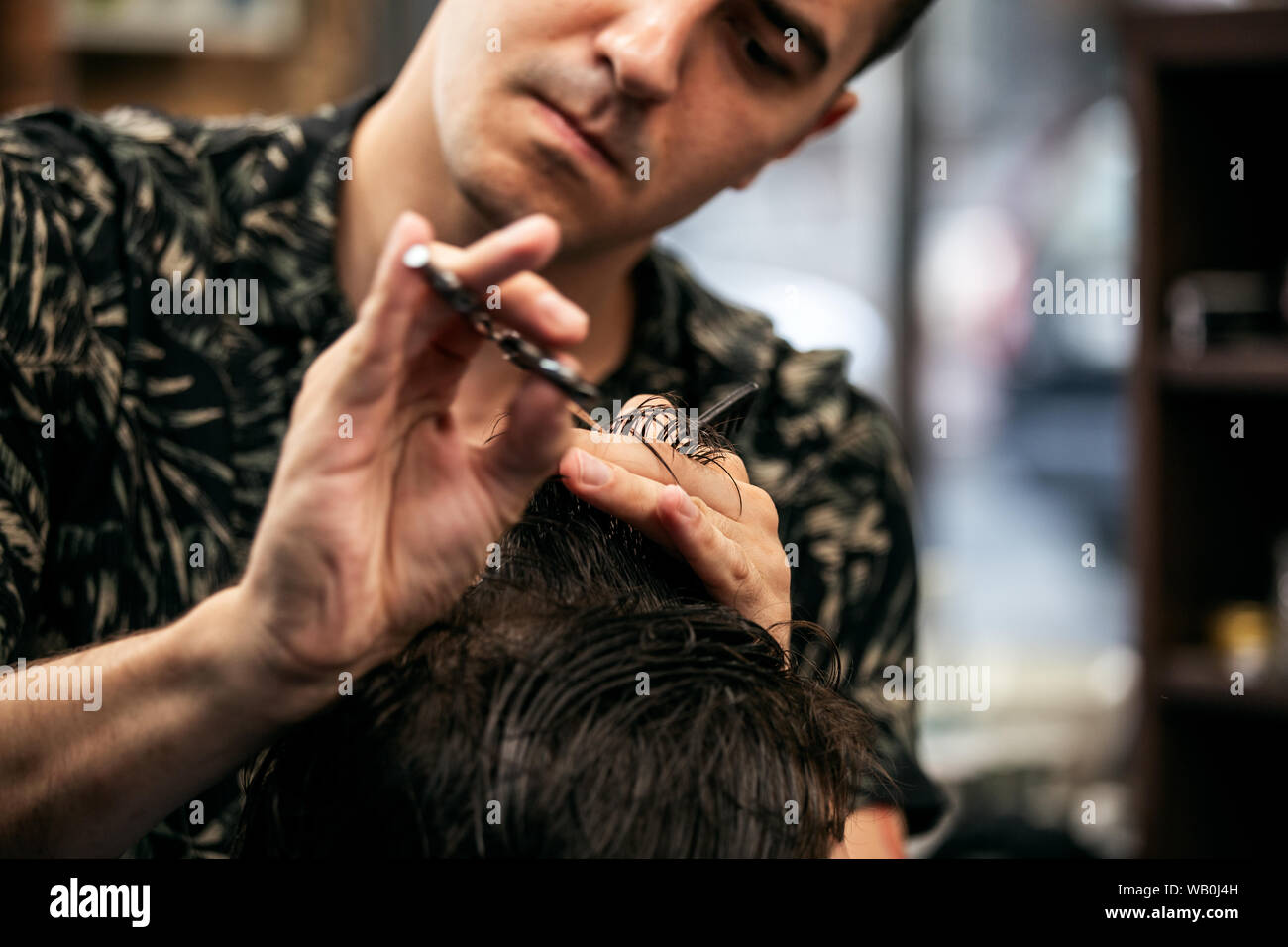 Barbershop. Close-up of man haircut, master does the hair styling in ...